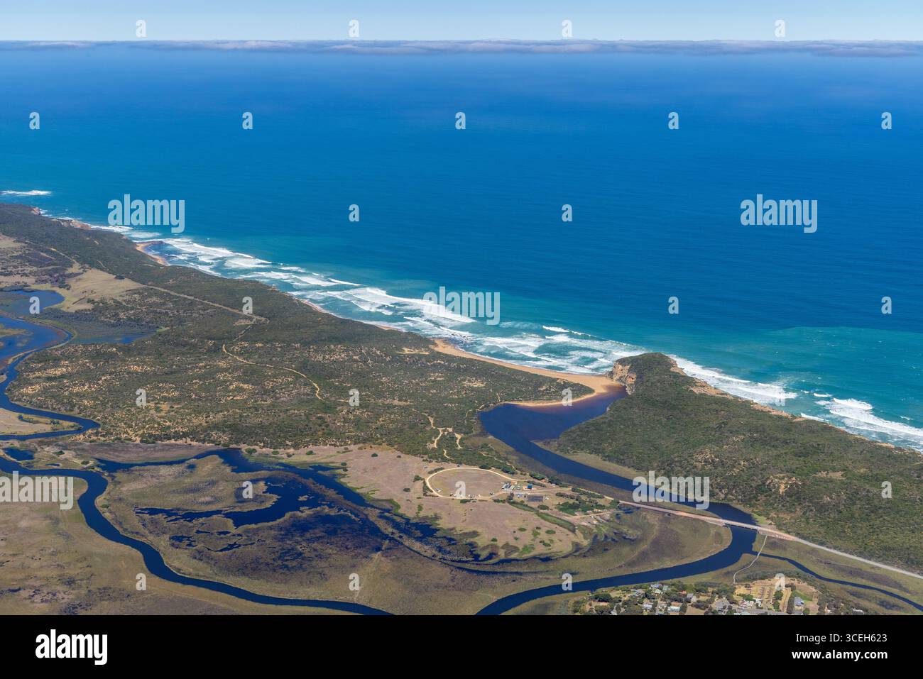 Aerial view of the winding river meeting the vast ocean, where the ...