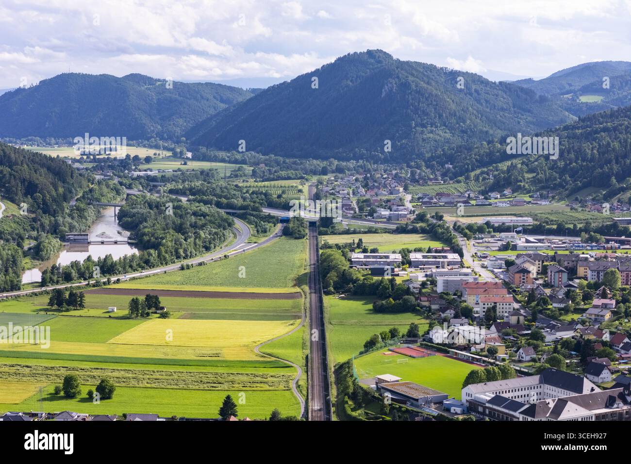 Aerial view of verdant fields meet the built environment under a vast ...