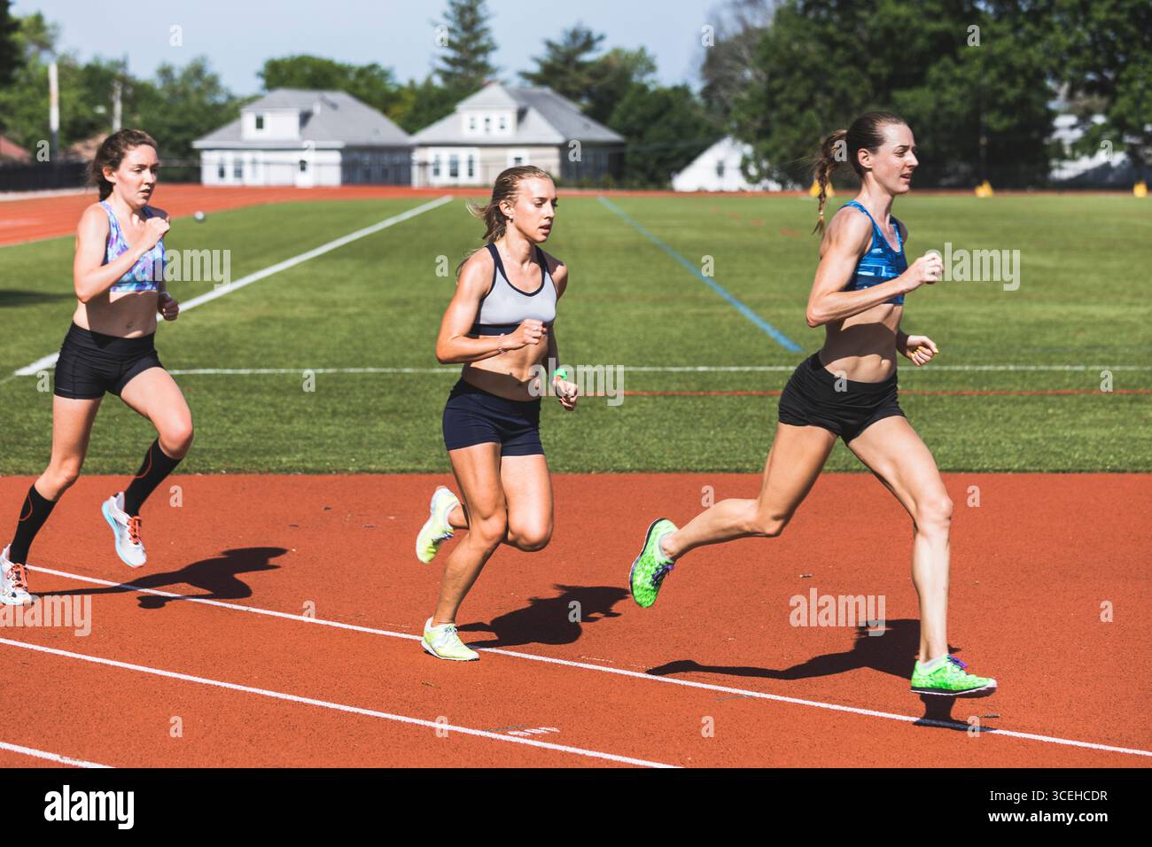 Fit female athletes train for long distance runs on a track Stock Photo ...