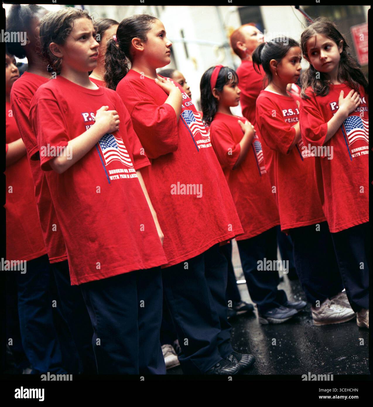 School girls of Queens Public Elementary School 164 stand in attendance ...