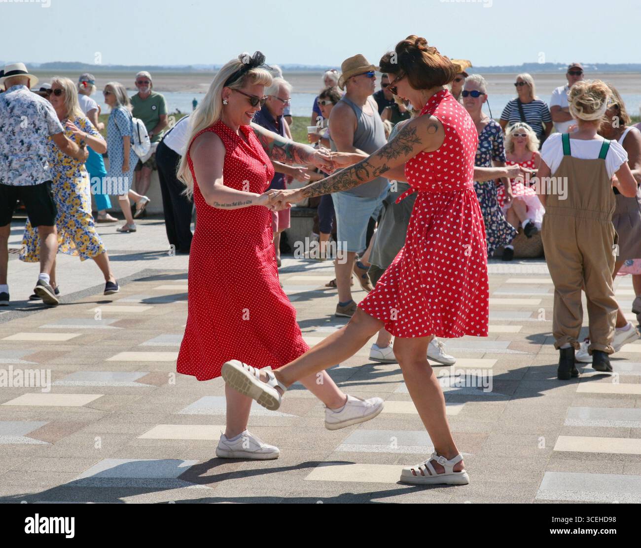 Two pretty ladies, dancing on the seafront Stock Photo - Alamy