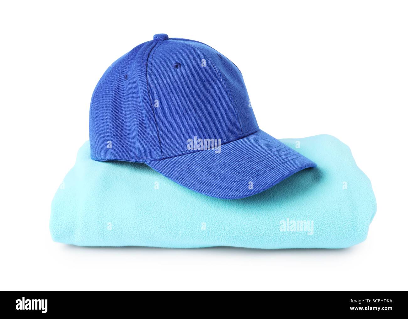 Blue baseball cap and folded t-shirt isolated on white. Mockup for ...