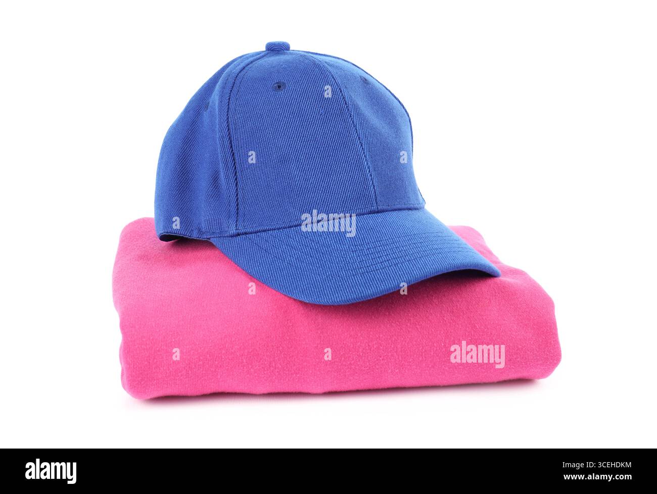Blue baseball cap and folded t-shirt isolated on white. Mockup for ...