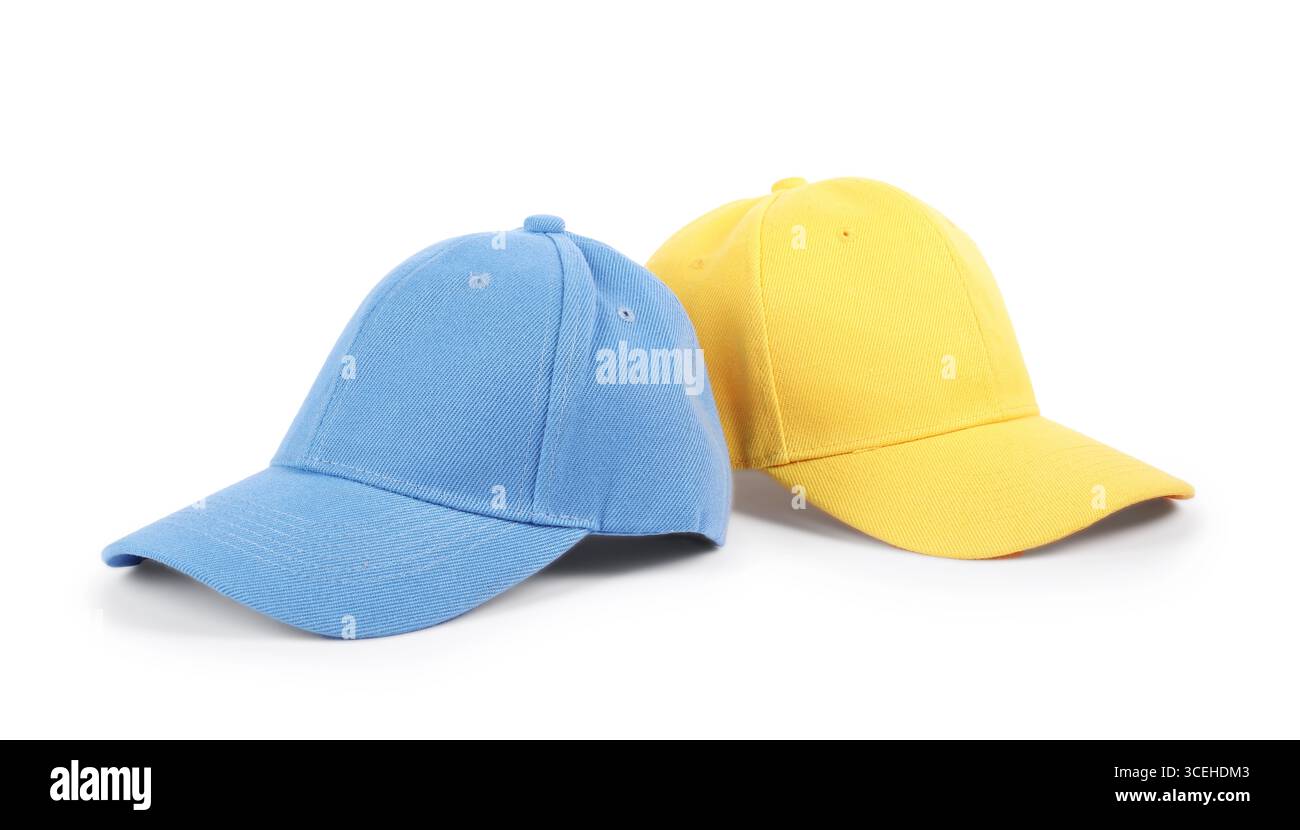 Blue and yellow baseball caps isolated on white. Mockup for design ...