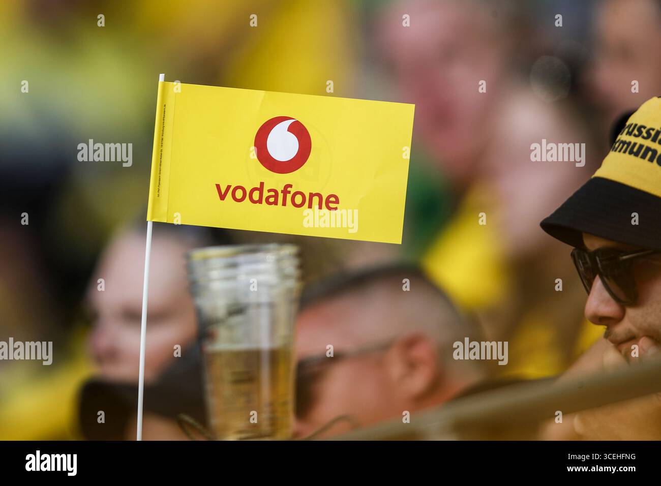 DORTMUND - Fans hold a Vodafone flag during a friendly match between ...