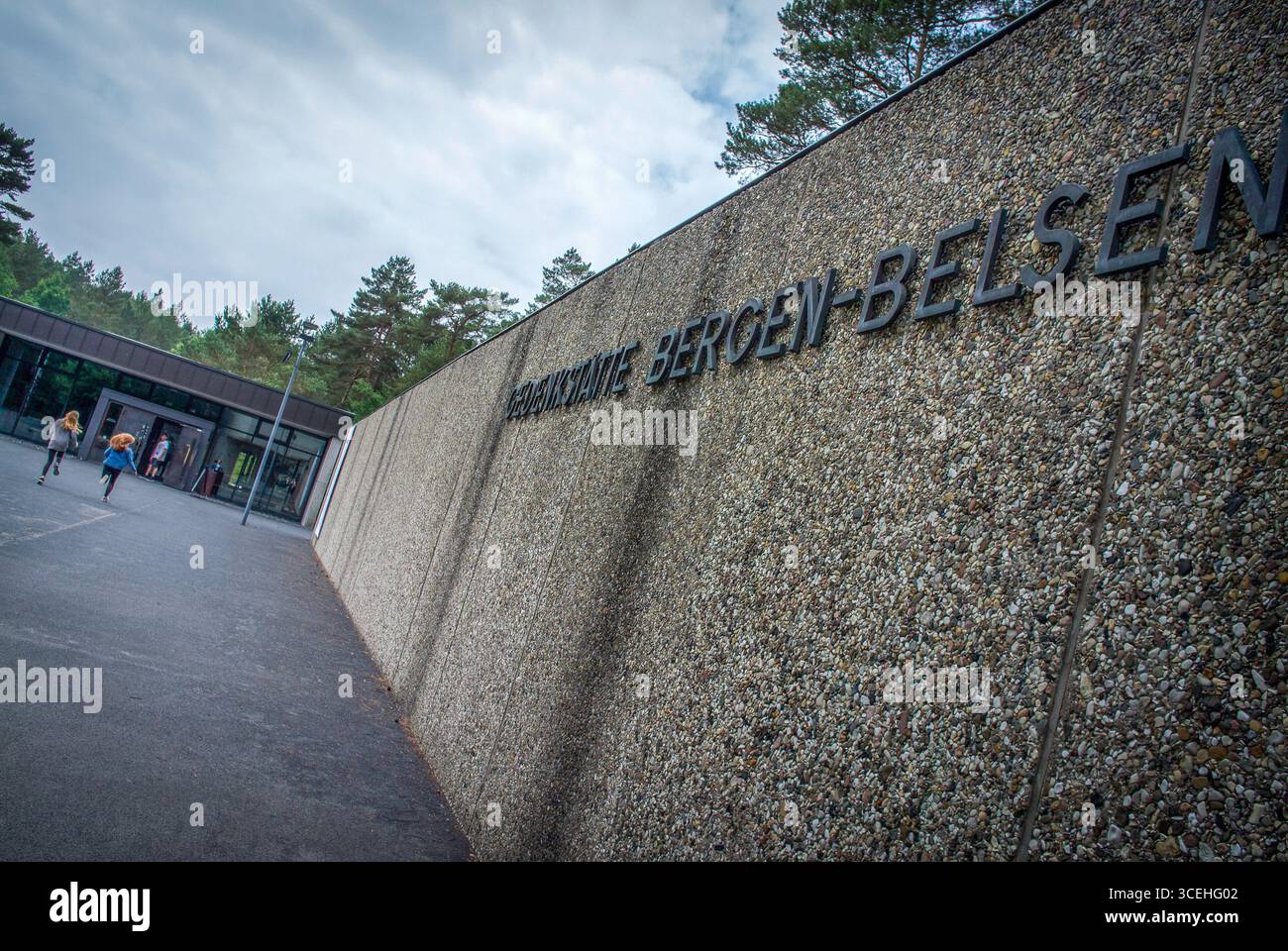 Children run towards the entrance and documentation centre at Bergen ...