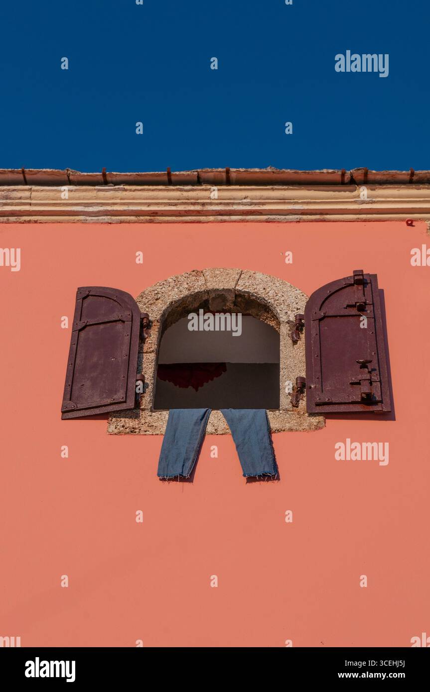 Bosnia Herzegovina: window with iron shutters and pants hanging out to ...