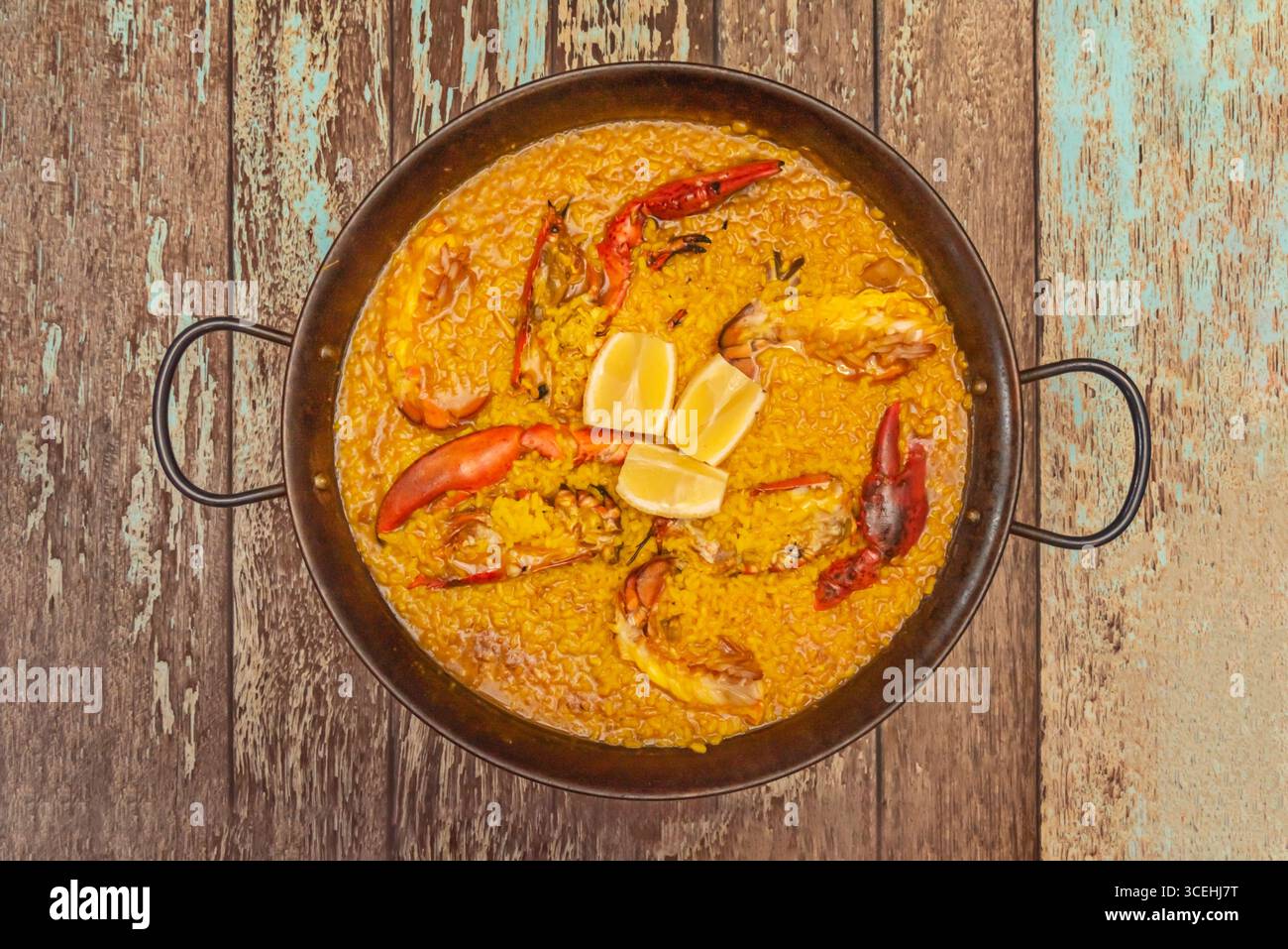 Lobster paella with whole shellfish as a garnish, served directly from ...