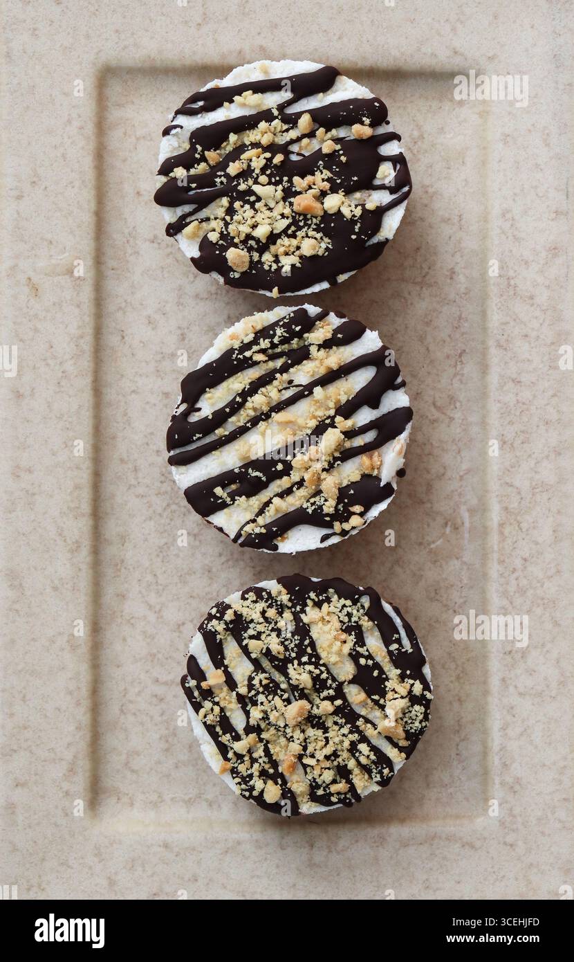 A top-down view of three healthy rice cakes, each topped with a white ...