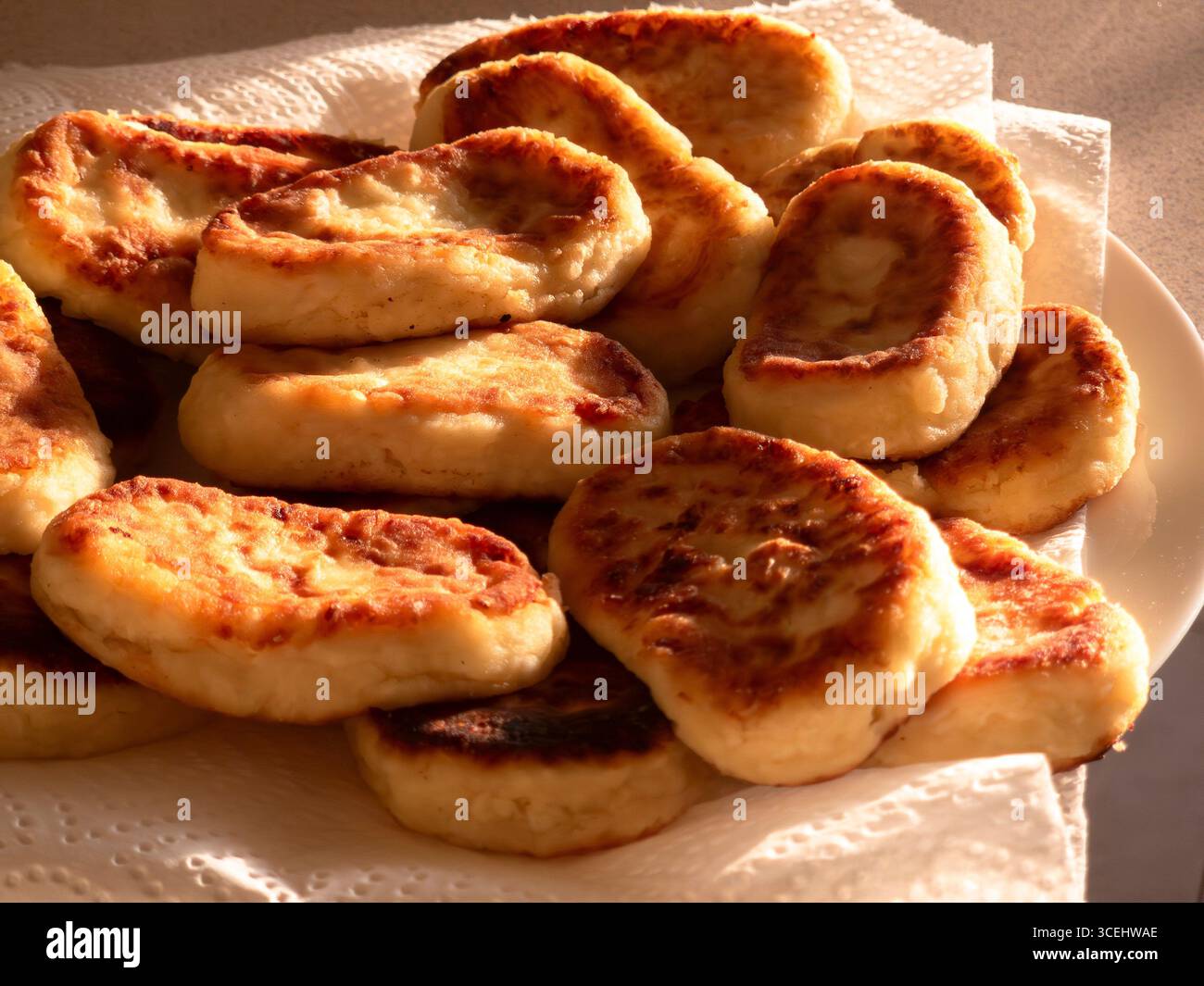 Freshly baked homemade pies cooling on a white paper towel, illuminated ...