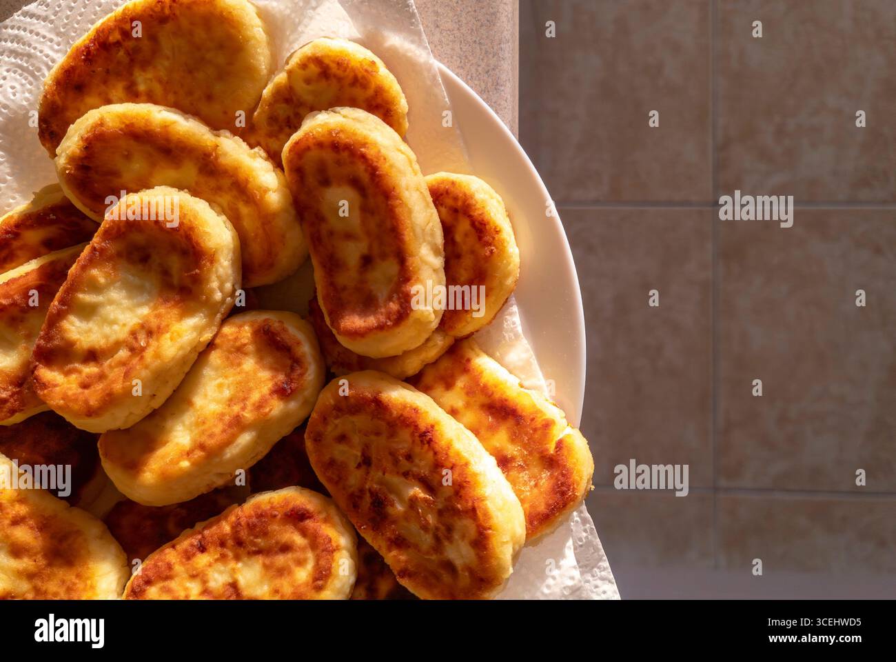 Freshly cooked syrniki, traditional Eastern European cheese pancakes ...