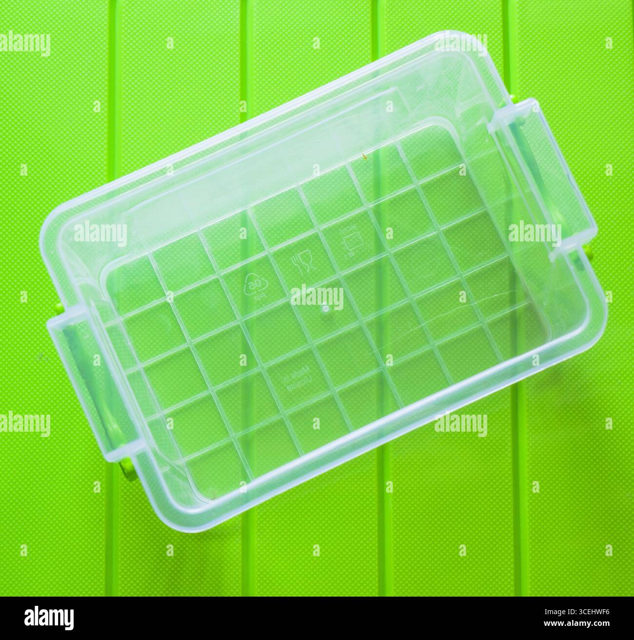 Empty transparent plastic food container with handles and microwave and ...