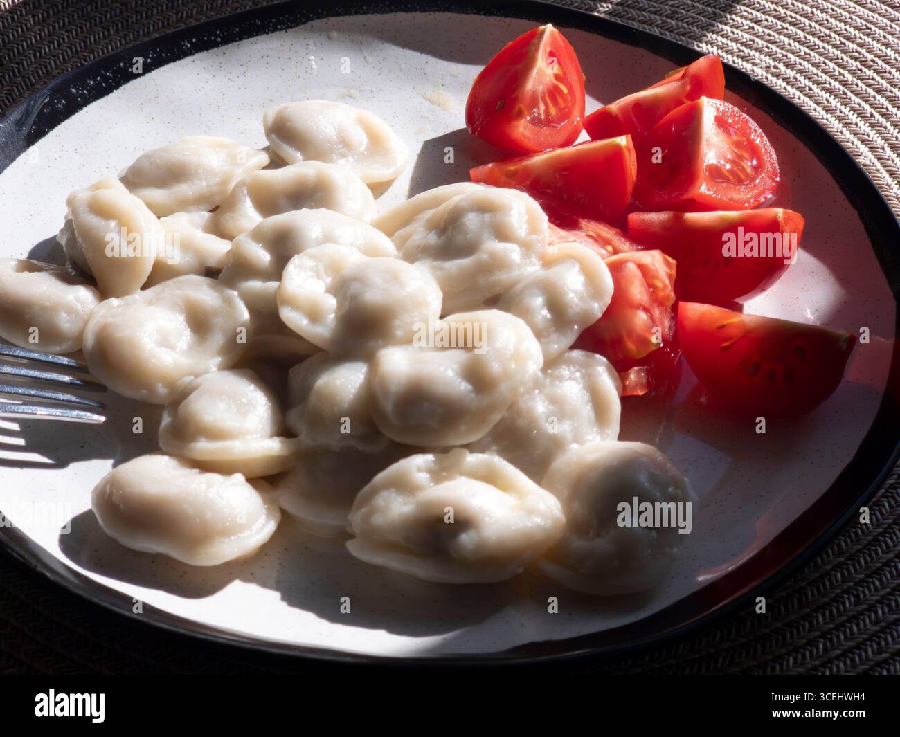 Delicious meat dumplings arranged on a plate, accompanied by fresh ...