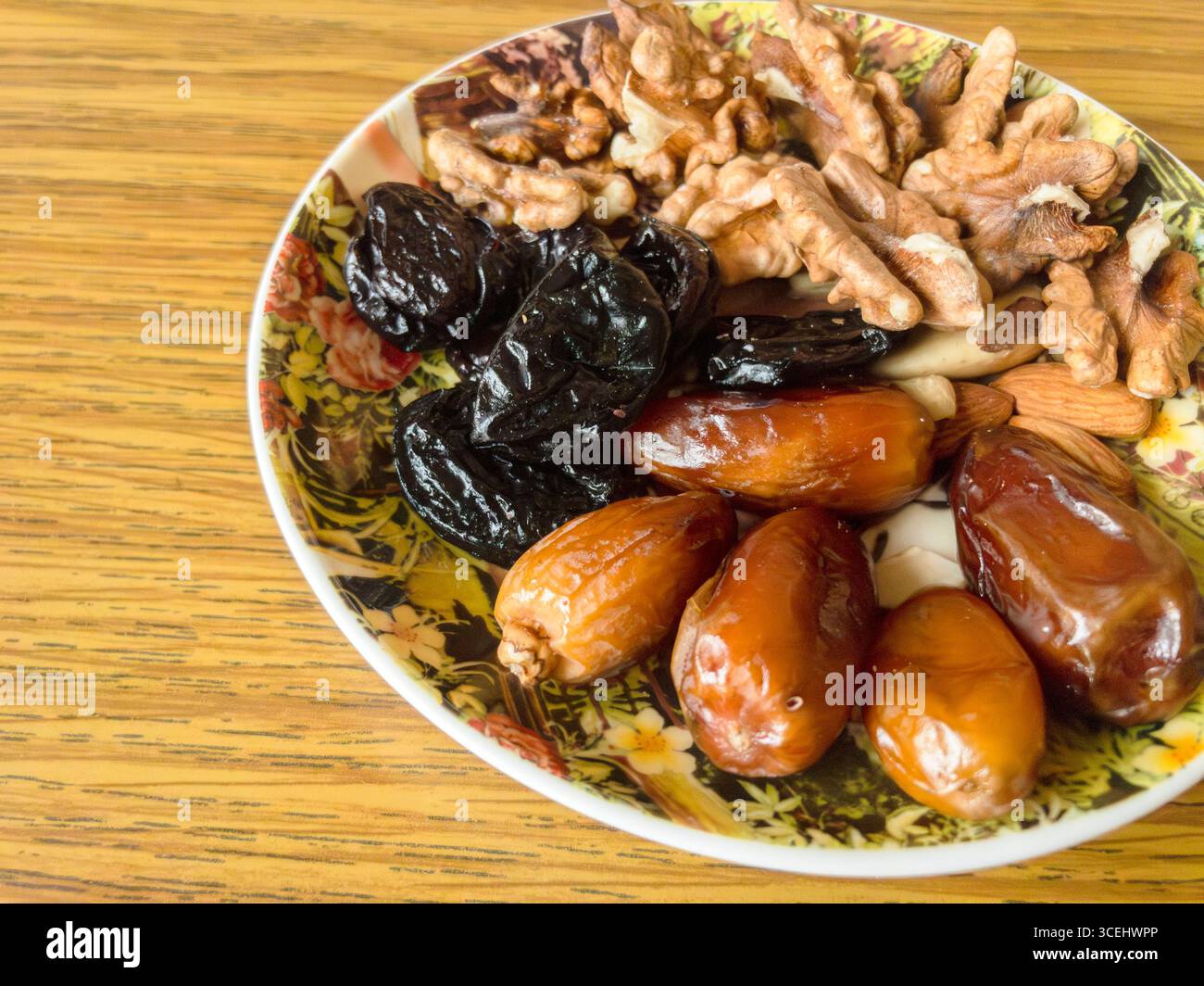 Walnuts, dates, prunes, almonds and brazil nuts are composing a healthy ...