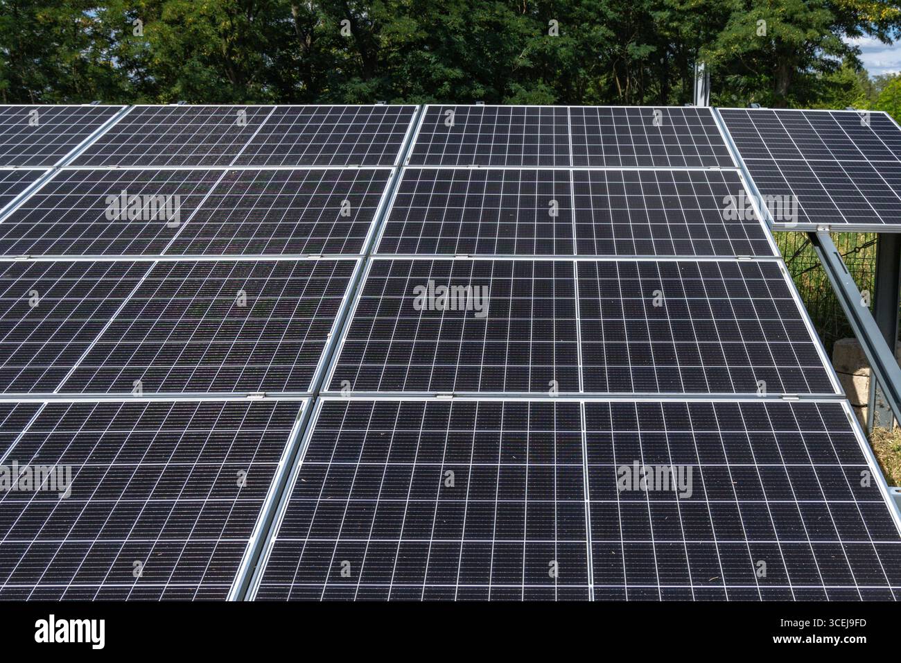 Photovoltaic solar panels installed in front of the house in the garden ...
