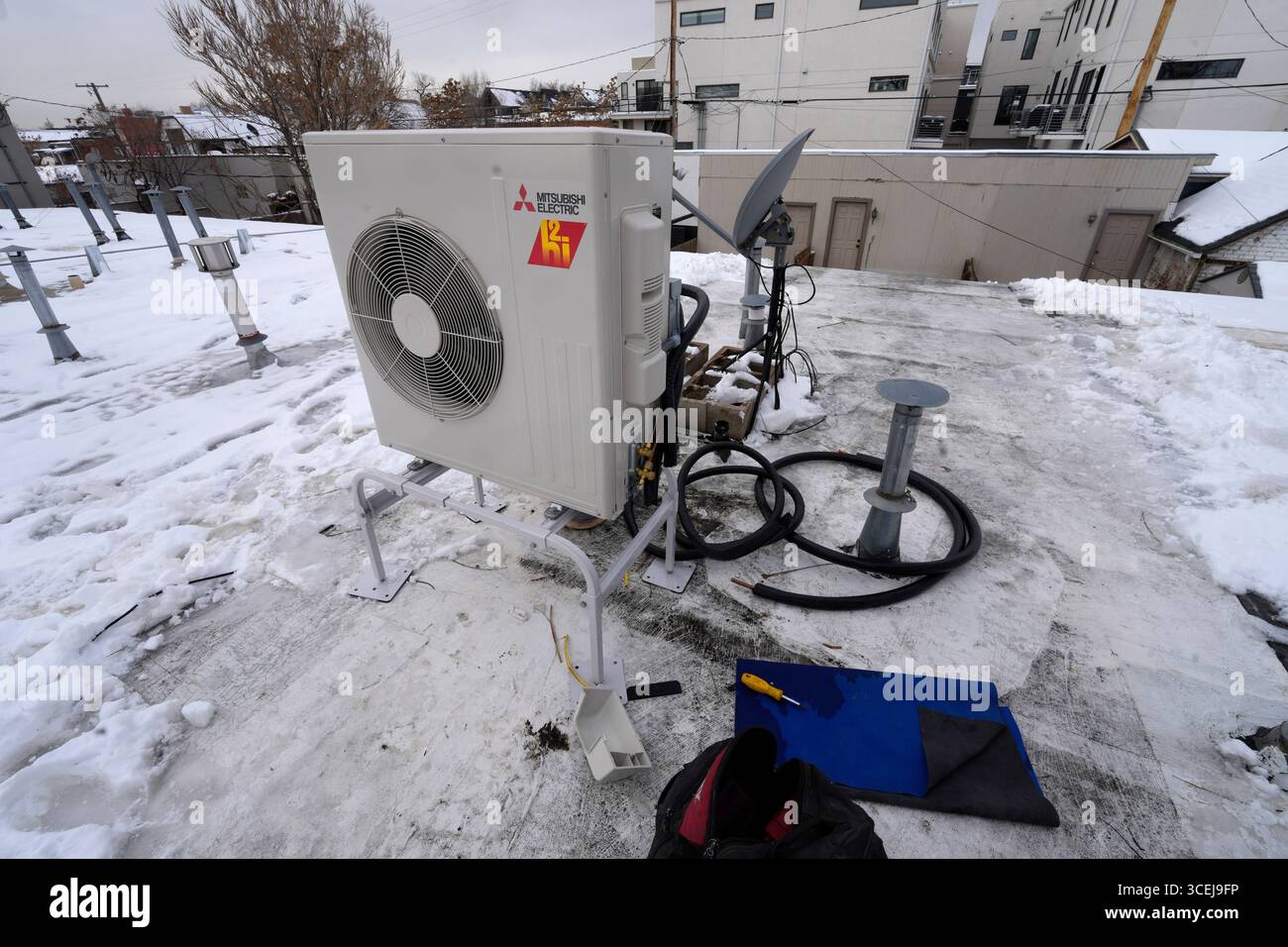 FILE - A condenser sits on the roof during the installation of a heat ...