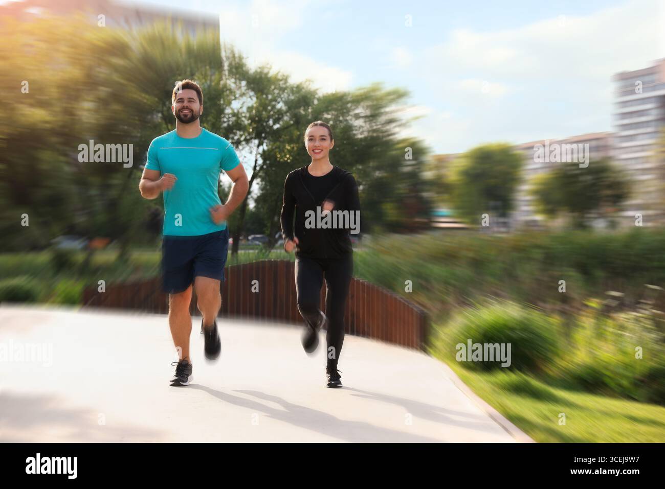 Woman and man in sportswear running outdoors, motion blur effect Stock ...