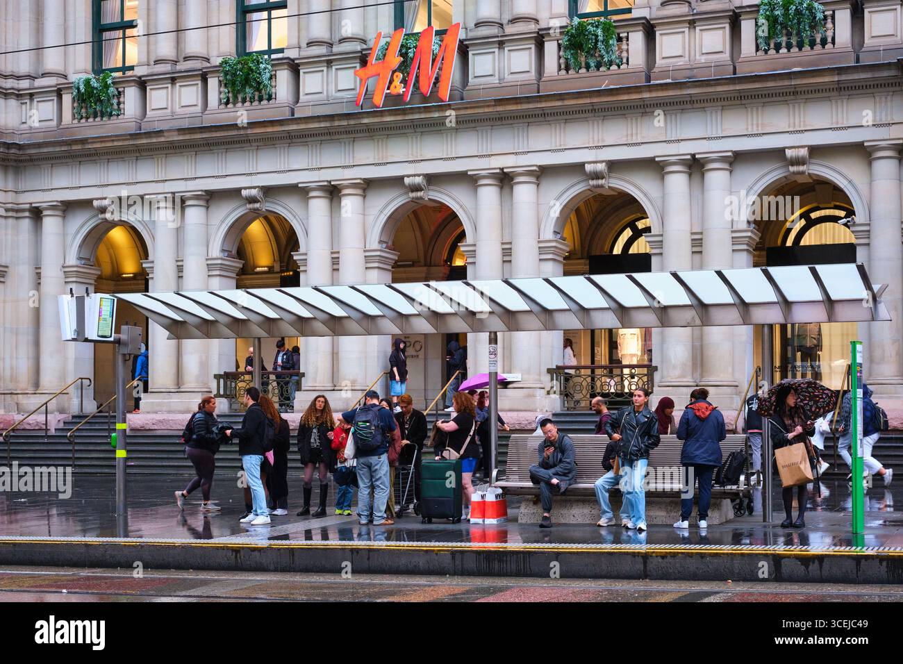 People waiting under a shelter at the tram stop outside the GPO ...