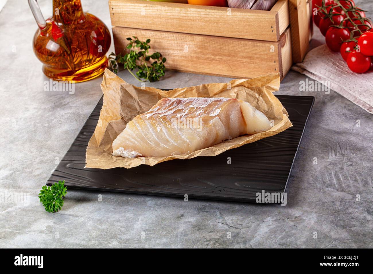 Raw cod fish fillet for cooking over board Stock Photo - Alamy