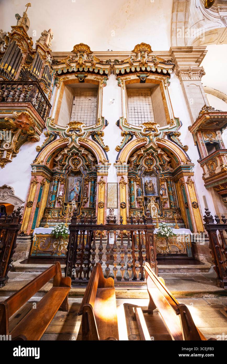 Sunlight illuminating wooden pews and colorful, ornate altars inside ...