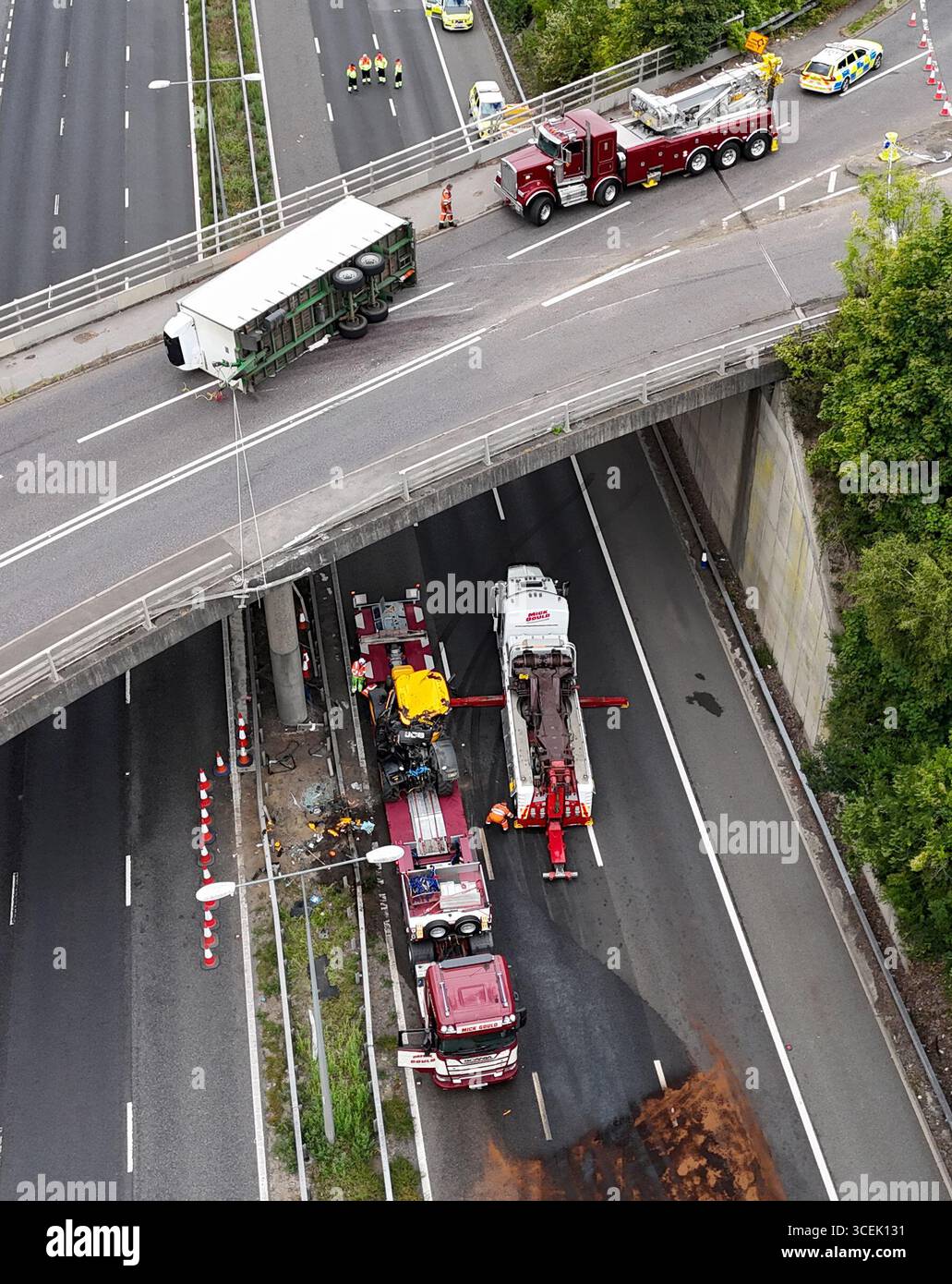An aerial view of a tractor that fell onto the M20 motorway from the ...