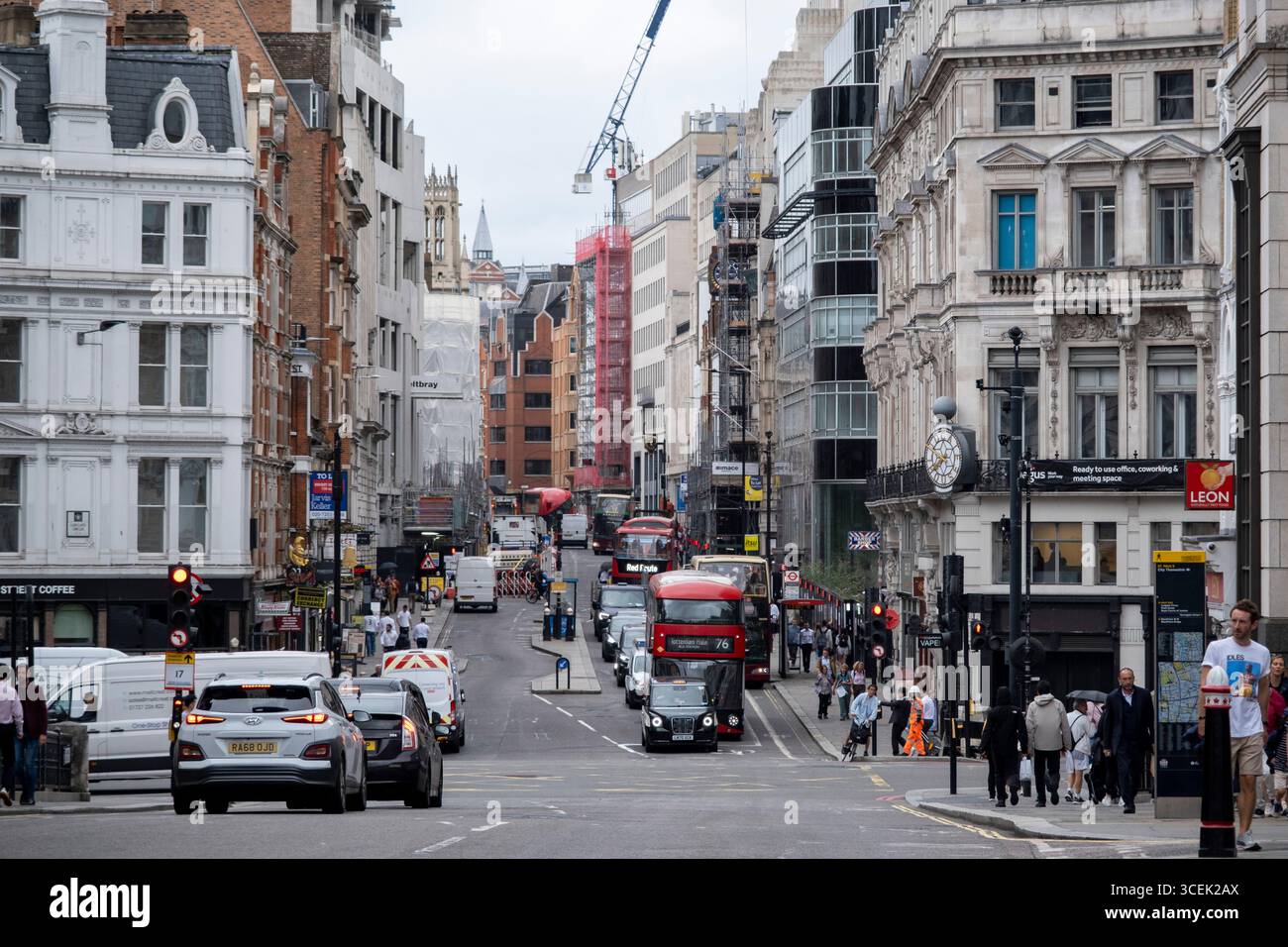 Traffic, buses, cyclists and pedestrians on the main road and ...