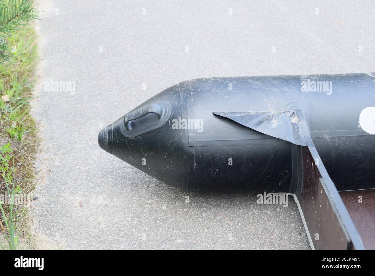 A large black inflatable object can be seen prominently on a road ...