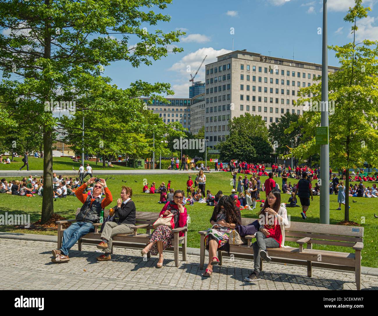 People sitting on benches enjoying the midday sun, Jubilee Gardens ...
