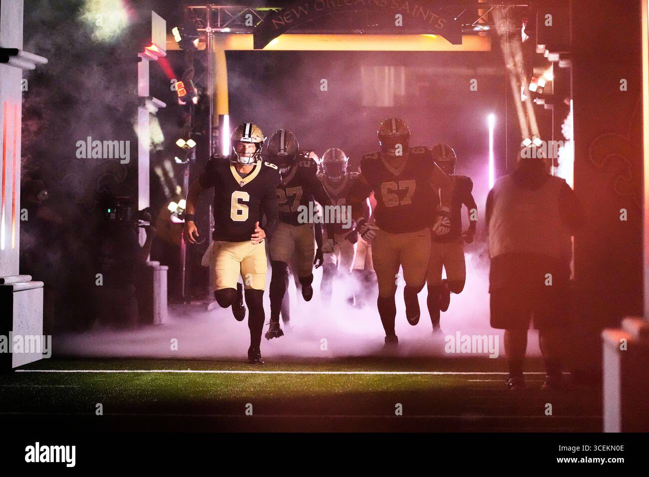 New Orleans Saints players run onto the field before an NFL preseason ...