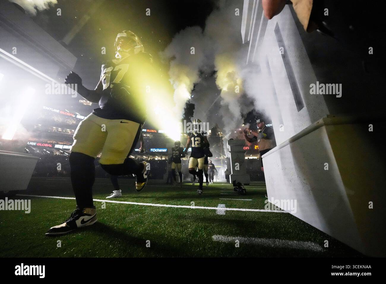 New Orleans Saints players run onto the field before an NFL preseason ...