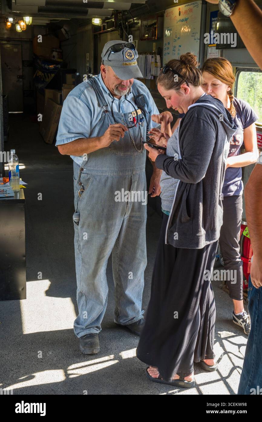 Woman showing man photos on her Smart-Phone aboard Hurricane Turn Train ...