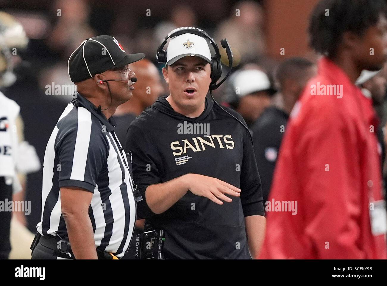 New Orleans Saints head coach Kellen Moore talks to an official in the ...