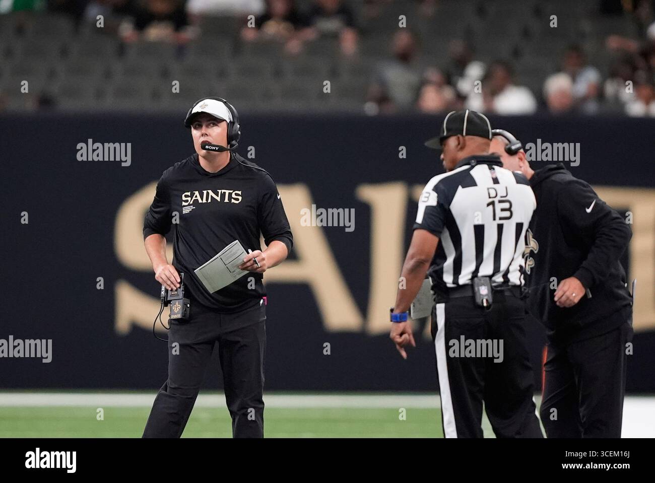 New Orleans Saints head coach Kellen Moore walks on the field in the ...