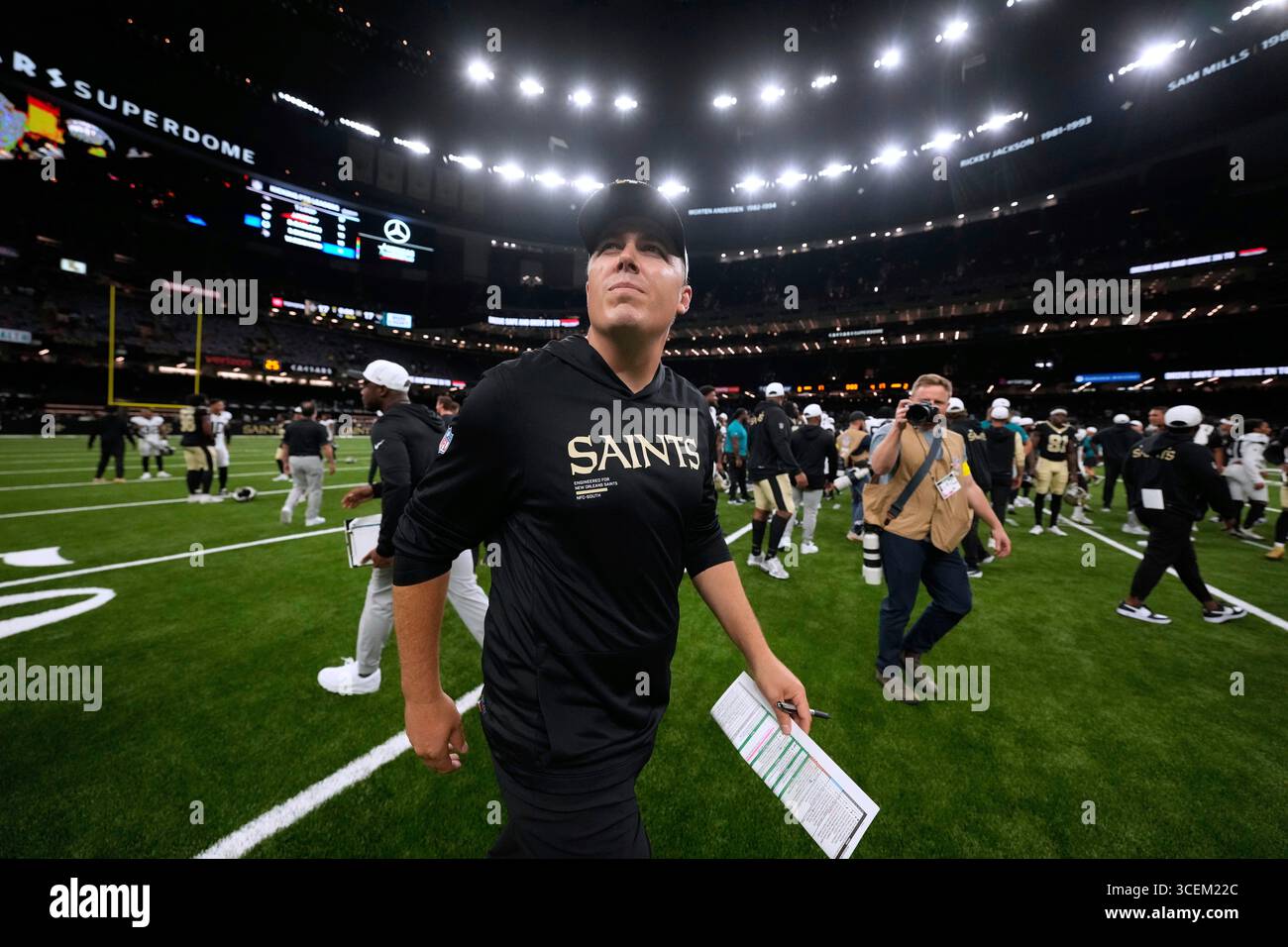 New Orleans Saints head coach Kellen Moore walks off the field after an ...