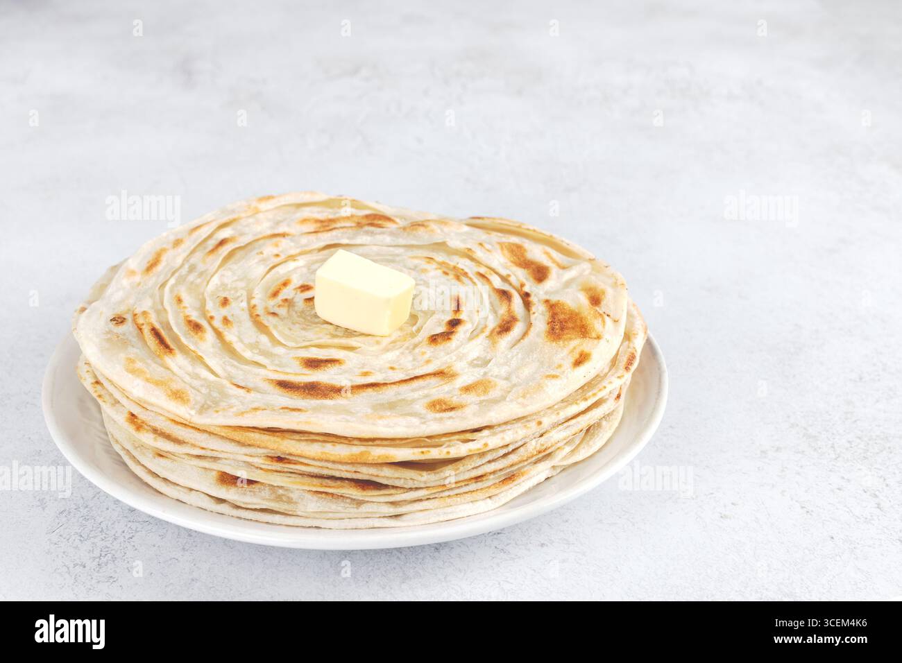 Traditional Indian paratha with butter on white background. Indian food ...
