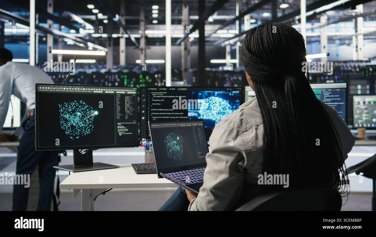 Data center admin uses AI technology on laptop for machine learning workloads. Server hub worker ...