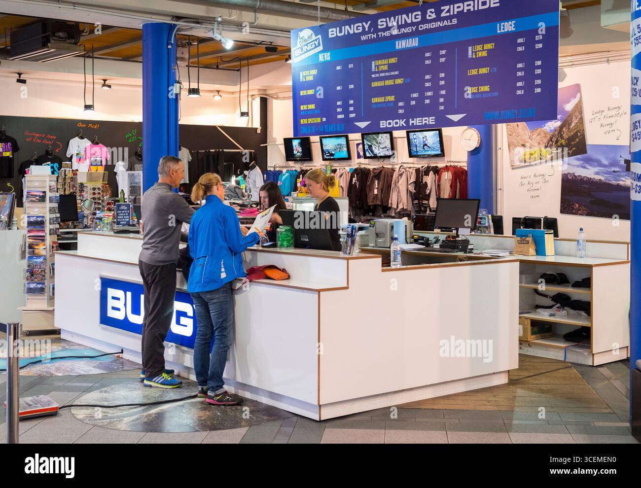 People at counter booking adventure activity, Queenstown, Otago, South ...