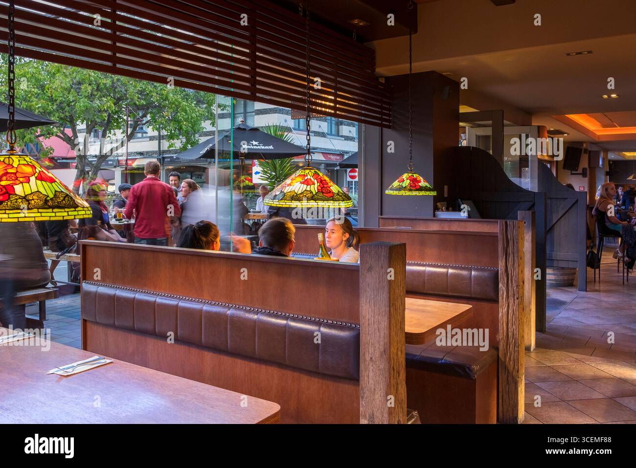 People sitting in booths inside restaurant eating in dinner, Queenstown ...