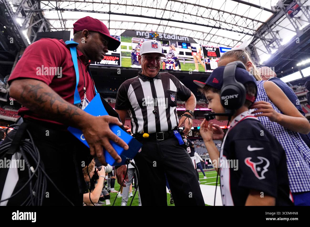 Referee John Hussey, center, shows children the replay monitor before ...