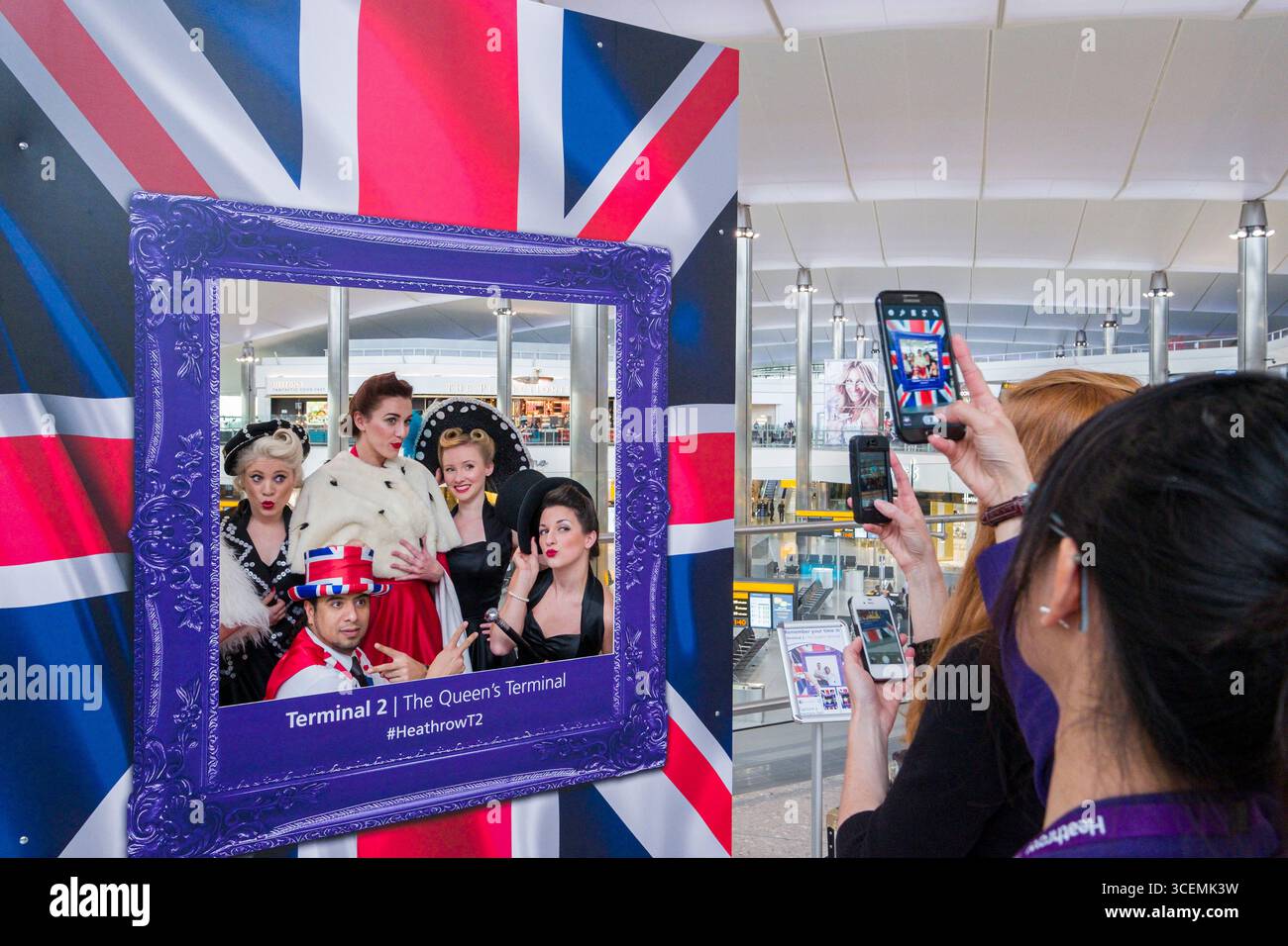 Women using smartphones to photograph performers dressed in costume ...