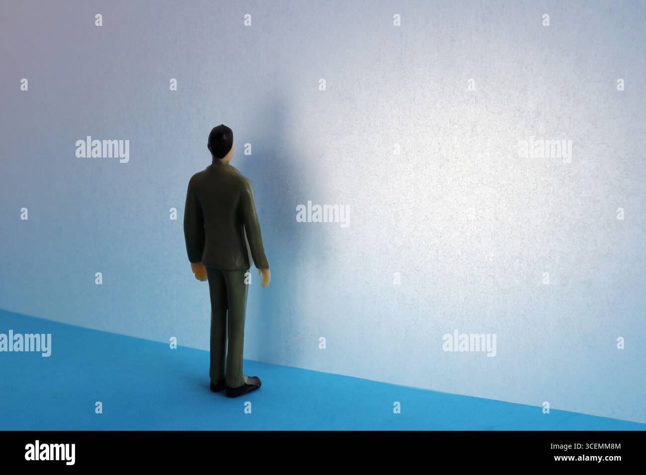 Executive facing the shadow of his partner separated by a wall Stock ...