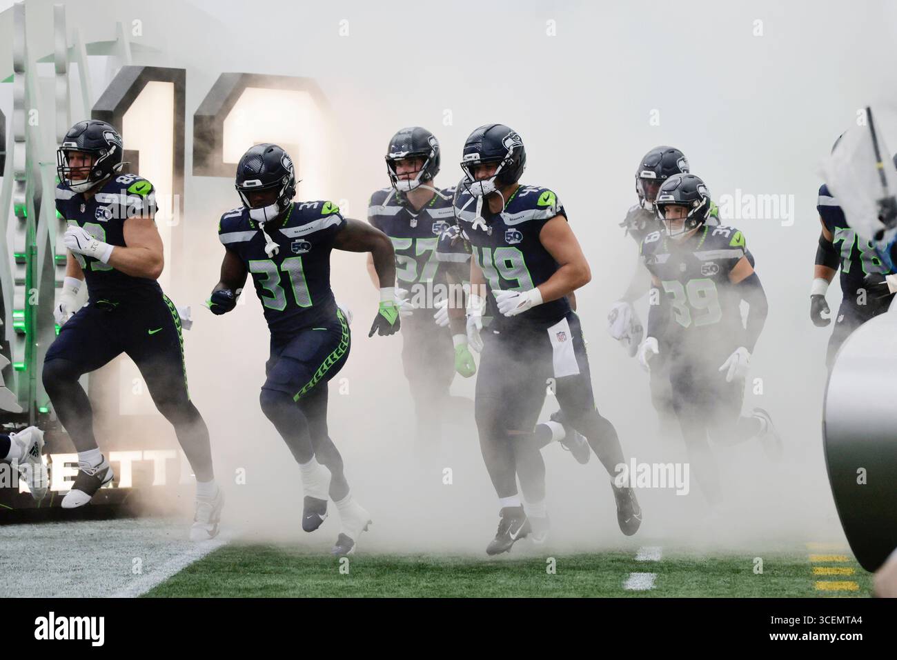 Seattle Seahawks players run to the field during introductions before ...