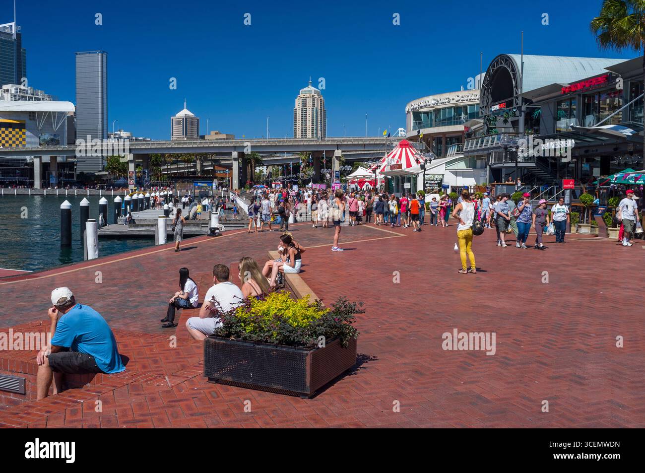 People walking on promenade in front of the Harbourside Shopping Centre ...