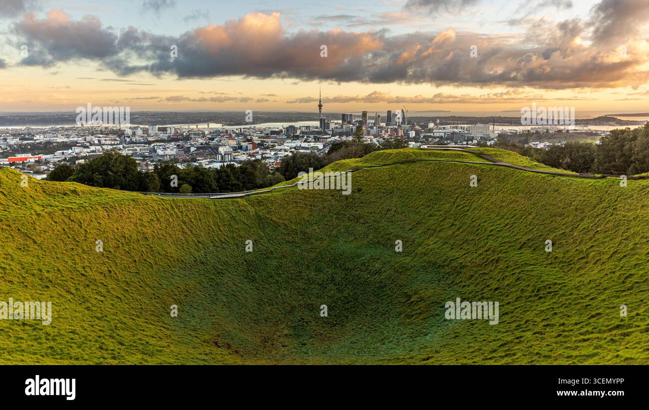 View of city behind the grass crater of the extinct volcano of Mount ...