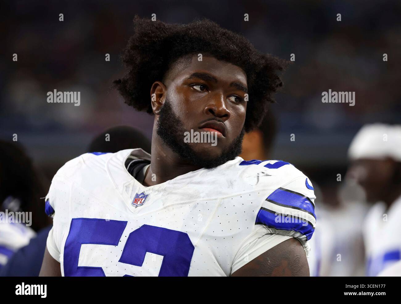 Dallas Cowboys guard Tyler Booker (52) stands on the sideline in a ...