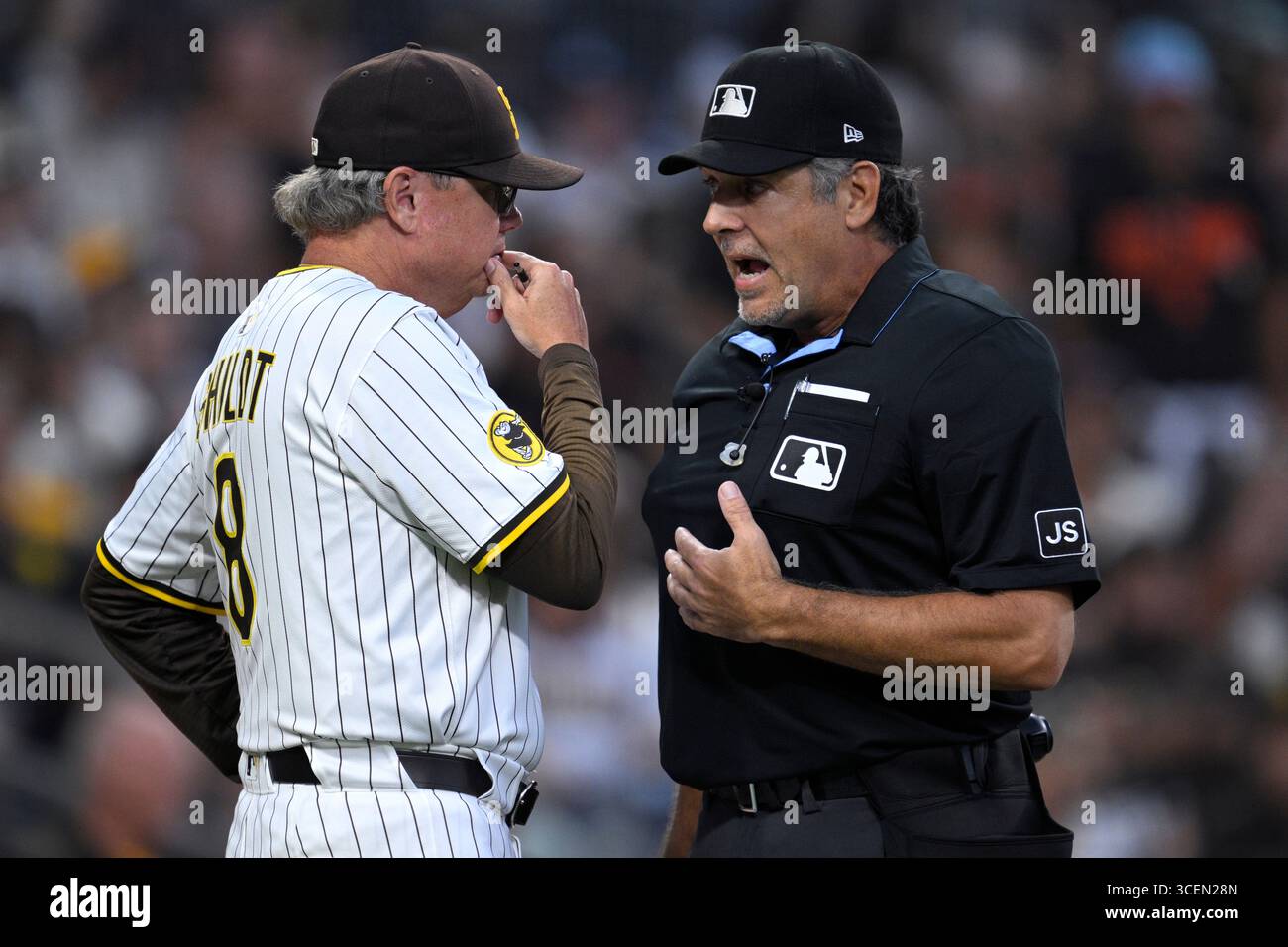 San Diego Padres manager Mike Shildt, left, talks to home plate umpire ...