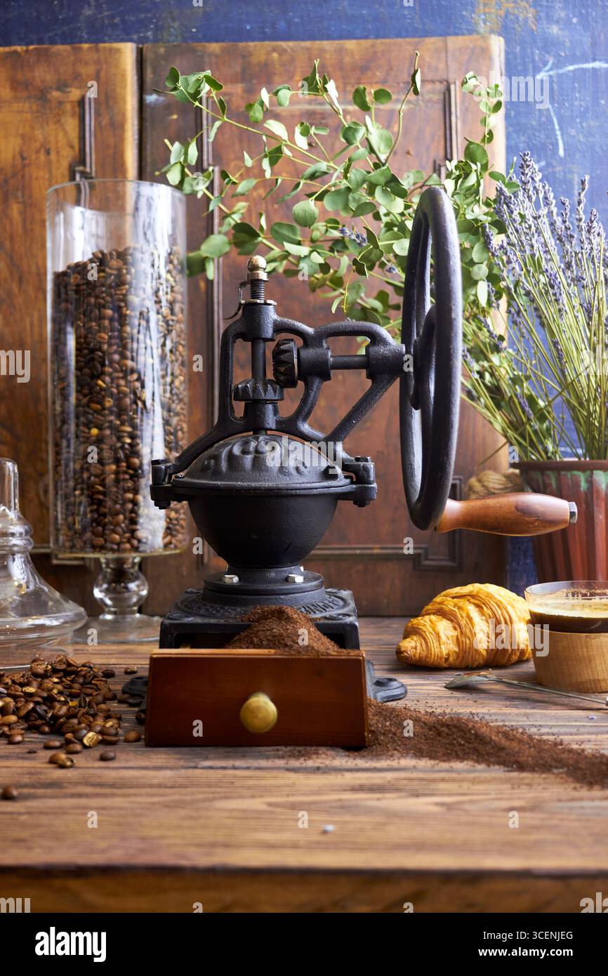 Rustic coffee scene with vintage grinder, roasted beans, ground coffee ...