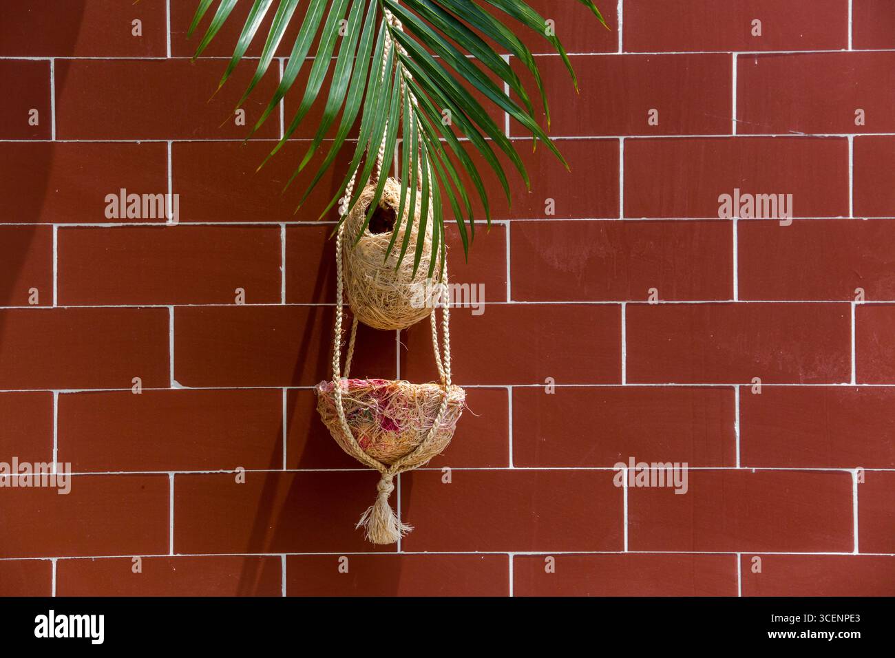 Handmade birds nest are hanging on the bricks wall. Interior Decoration ...