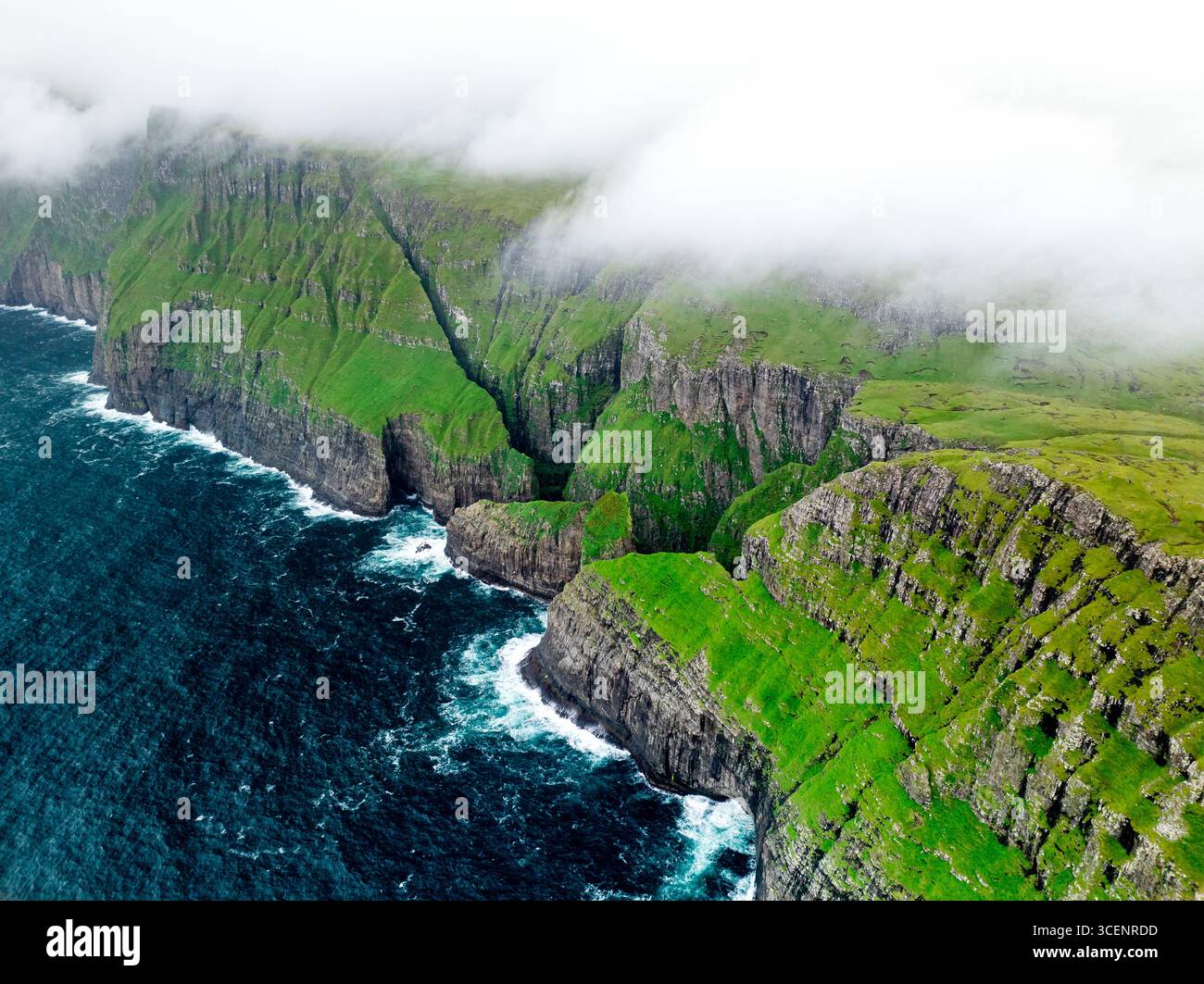 Aerial view of dramatic coastal cliffs meet the turbulent sea, the ...