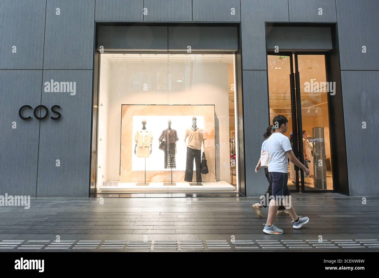 Shenzhen daily life People walking in front of the Sweden brand COSs ...